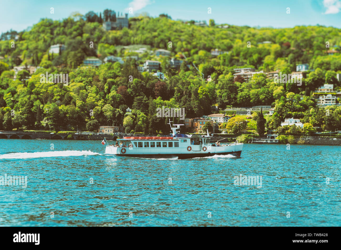 Small excursion boat floating on the Como lake in Italy Stock Photo - Alamy