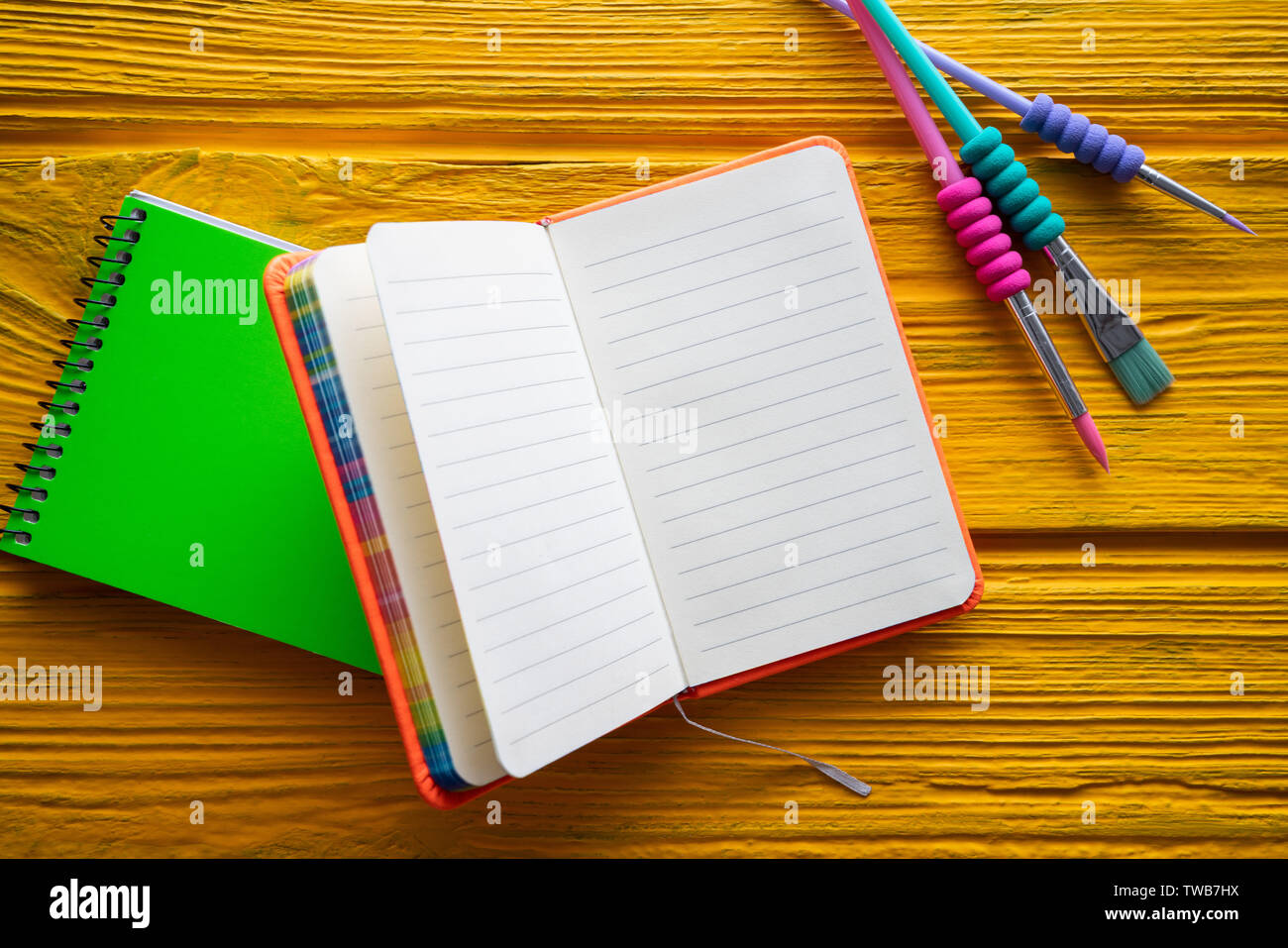 Back to school supplies notebook an brushes vivid colorful neon color ...