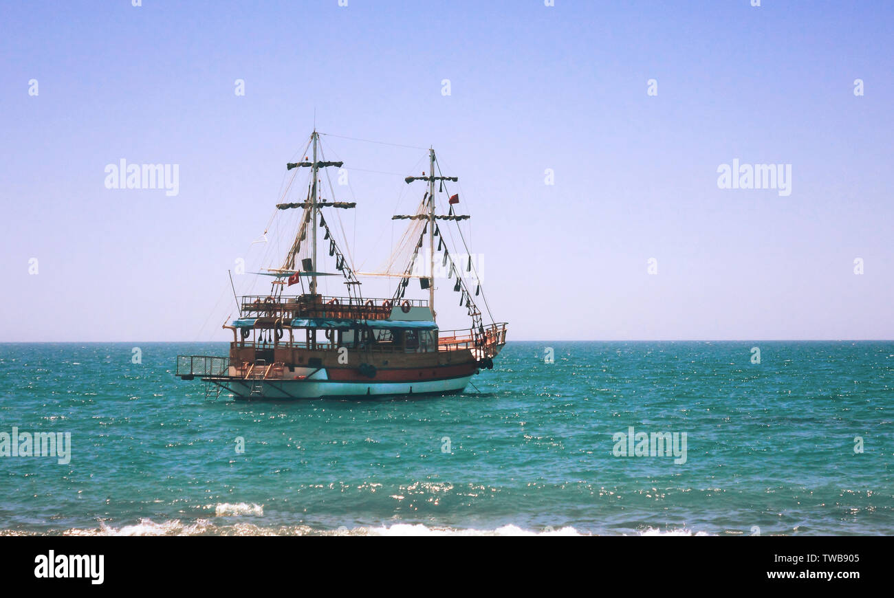 A small sailing vessel for sea trips near beach resort Stock Photo - Alamy