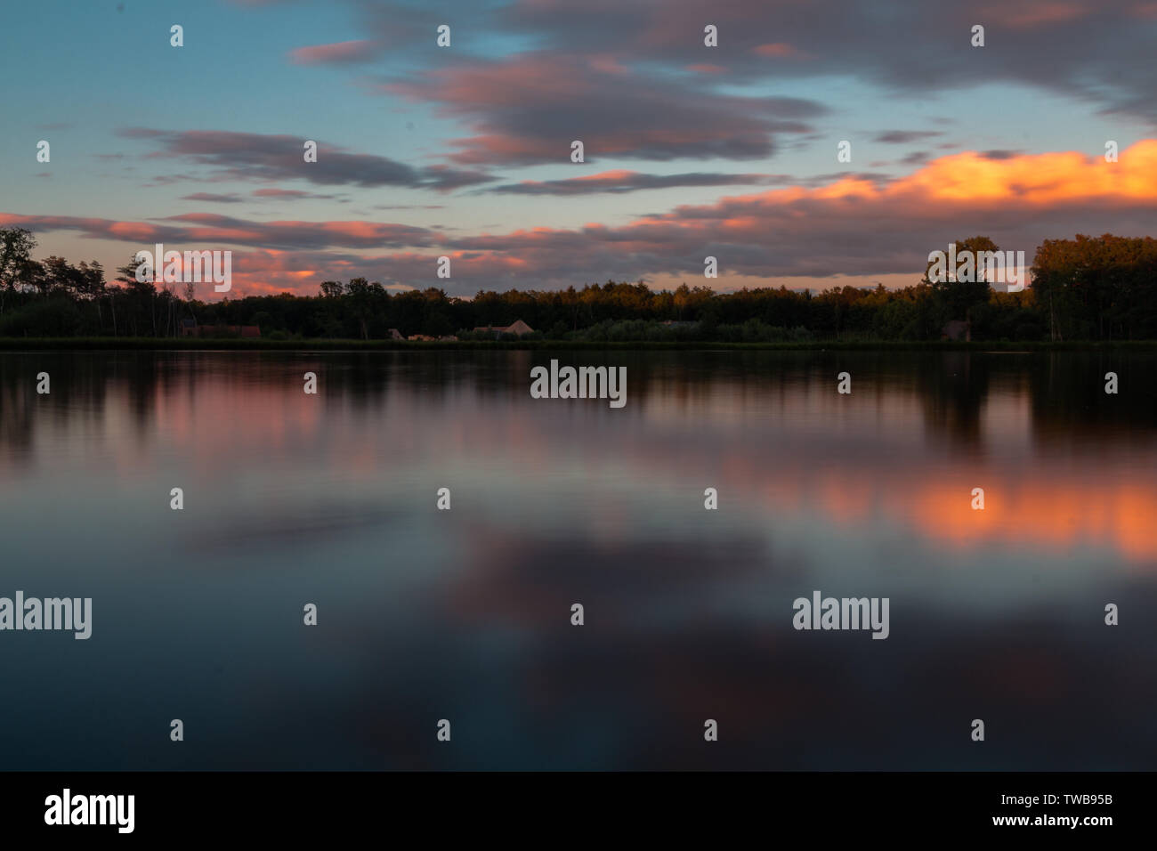 A long exposure of a colorful sunset with reflections at the cycling ...