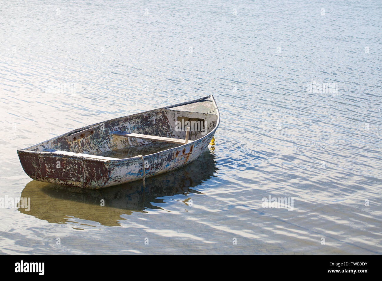 A old boat abandoned on the water Stock Photo - Alamy