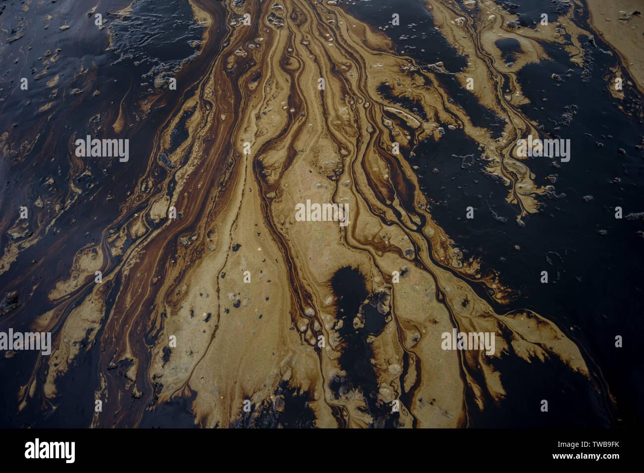 Oil sludge contaminating the sea during the oil spill disaster in Samet ...