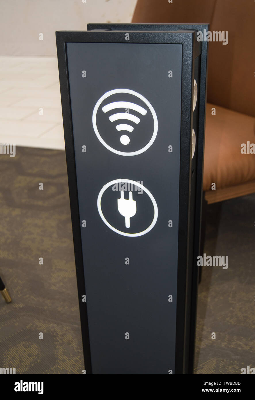 Stand tower for charging mobile phones in a shopping center, the sign ...