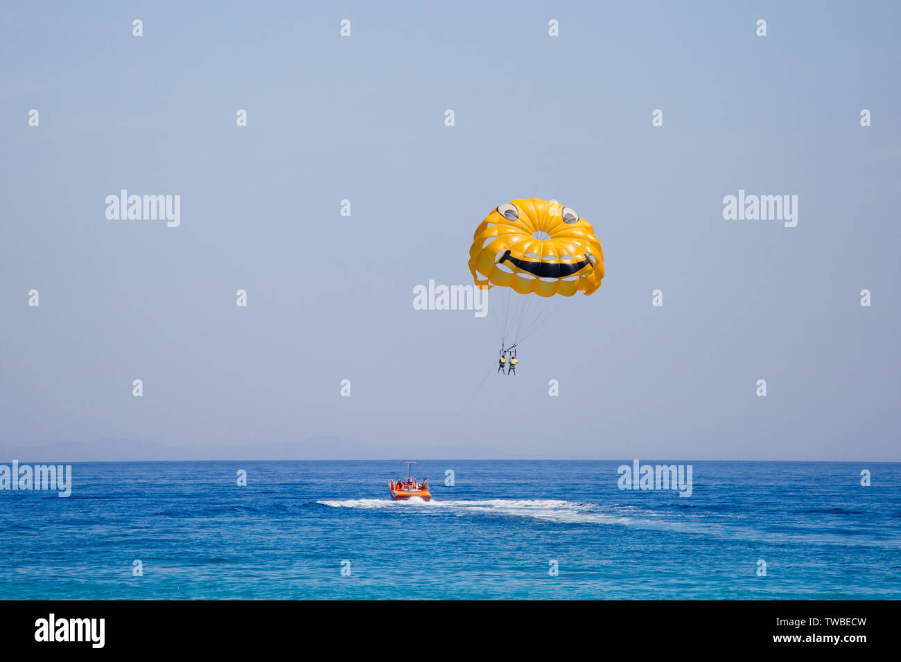 Parasailing water amusement - flying on a parachute behind a boat on a ...