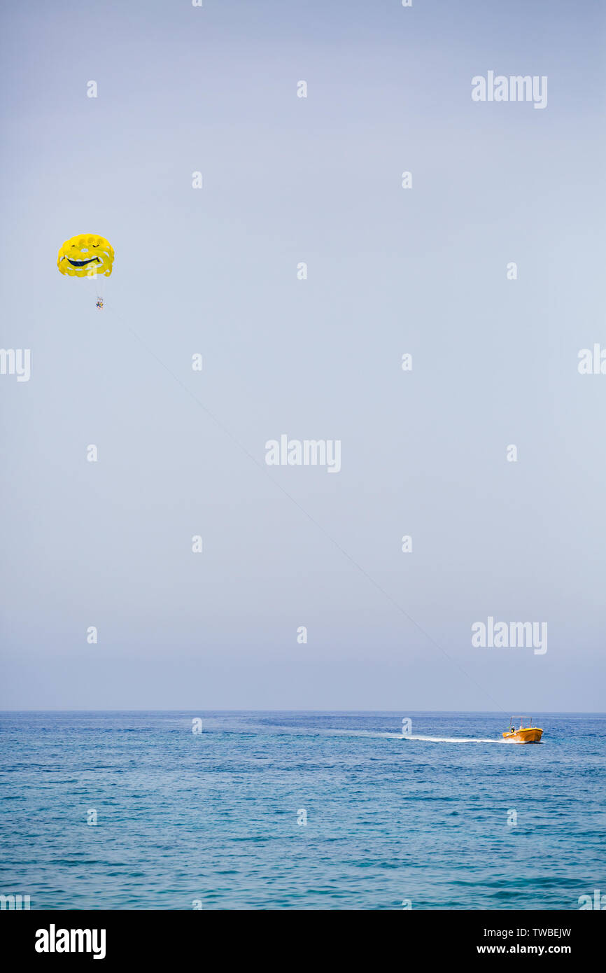 Parasailing water amusement - flying on a parachute behind a boat on a ...