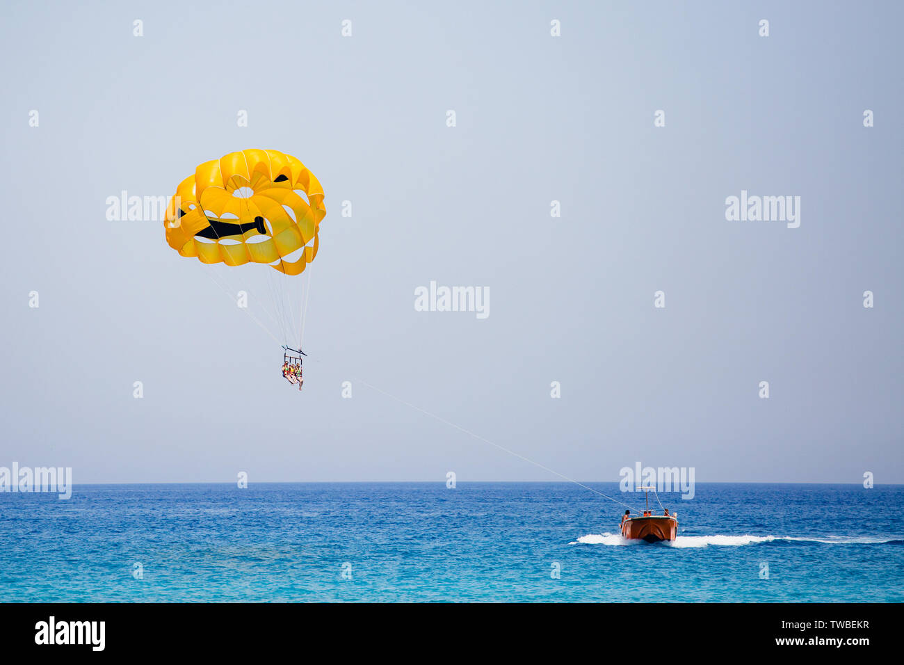 Parasailing water amusement - flying on a parachute behind a boat on a ...