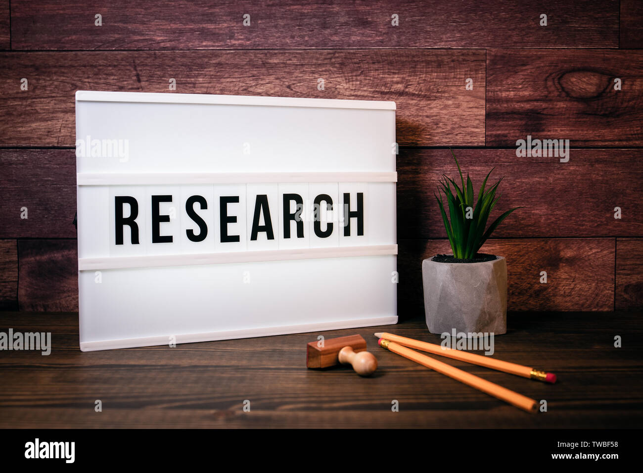 Research. Text in lightbox Stock Photo - Alamy
