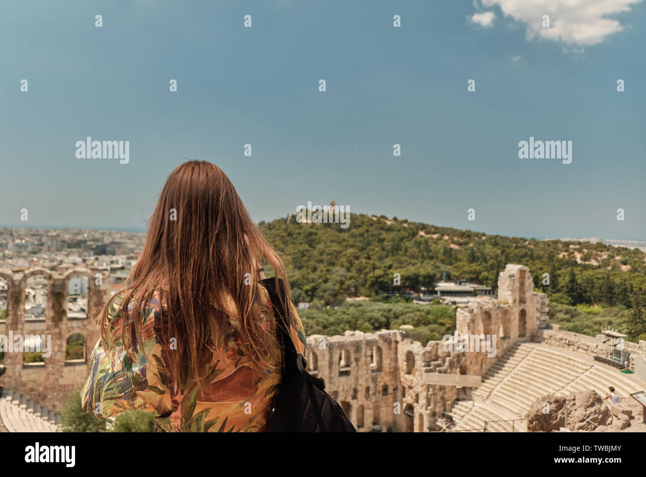 girl with red hairs and colorful dress taking photo with her smart ...