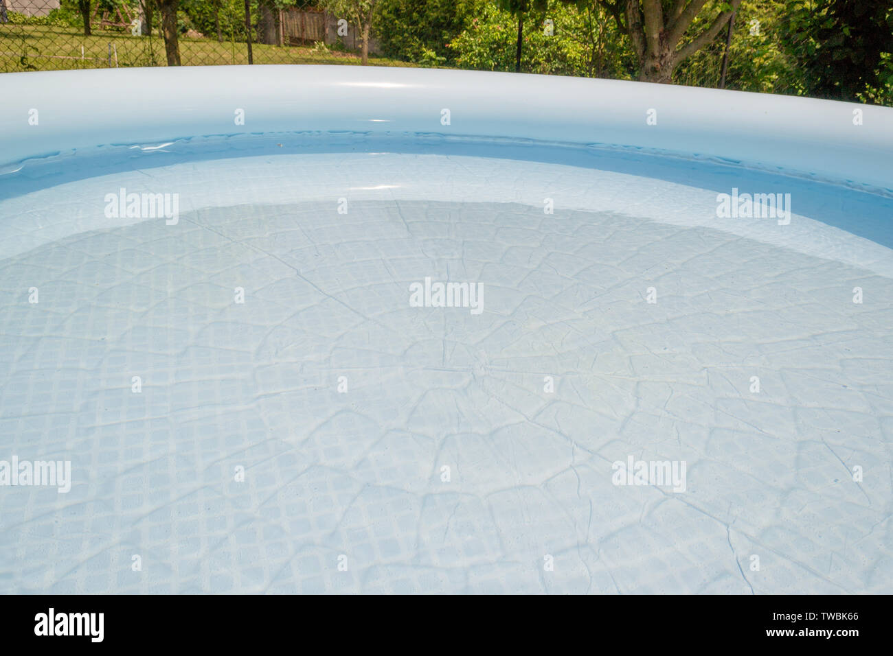 A round, blue, garden pool for children Stock Photo - Alamy