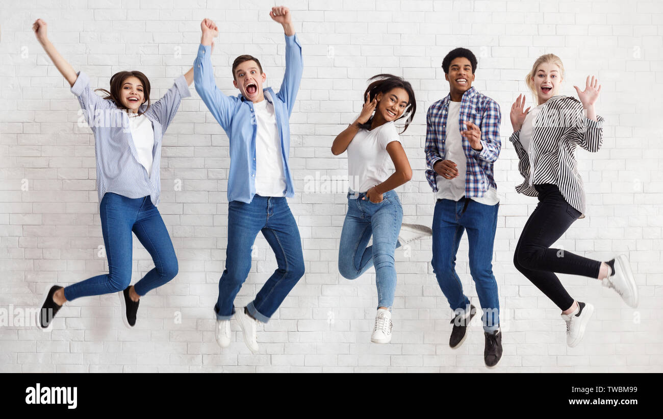Happy students jumping on white background, passed exams and having fun ...