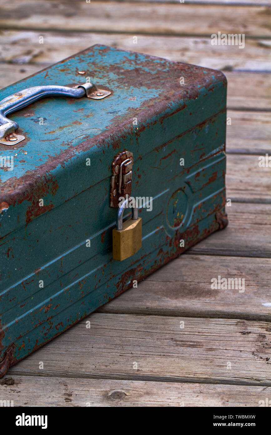 Rusty old toolbox locked up sitting on a wood Stock Photo - Alamy