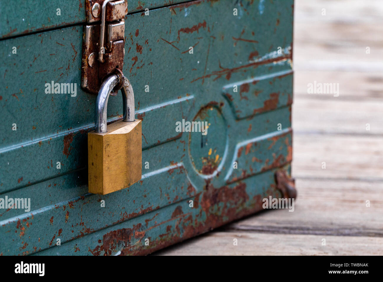 Rusty old toolbox locked up sitting on a wood Stock Photo - Alamy