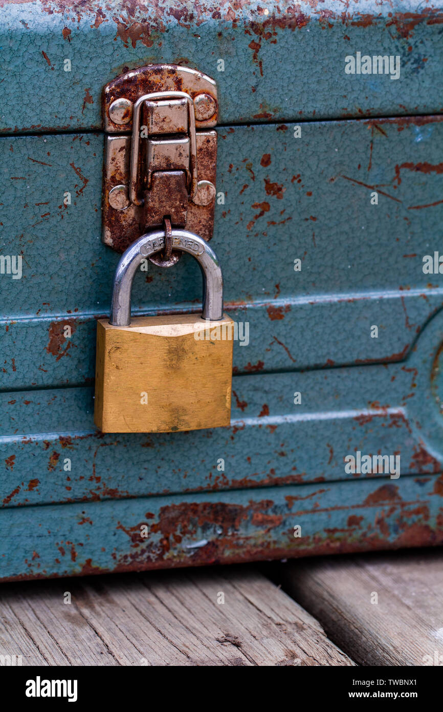 Rusty old toolbox locked up sitting on a wood Stock Photo - Alamy