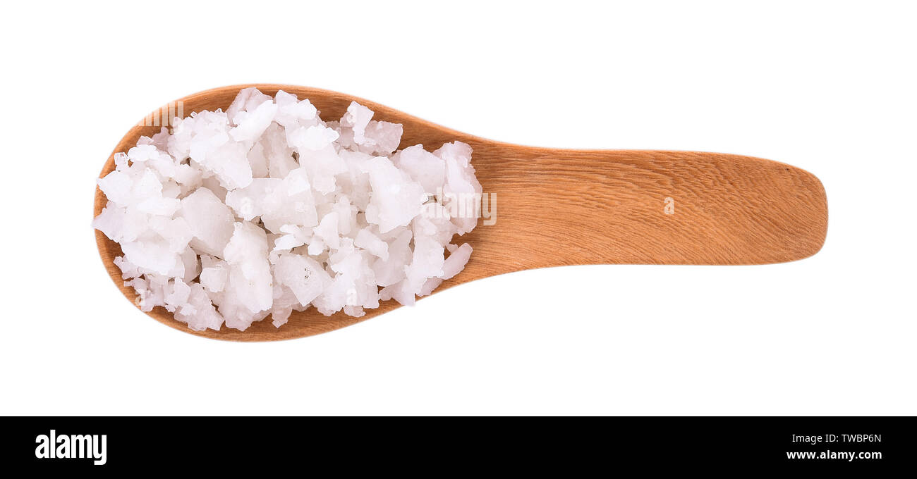Sea salt in wooden spoon on white background Stock Photo - Alamy