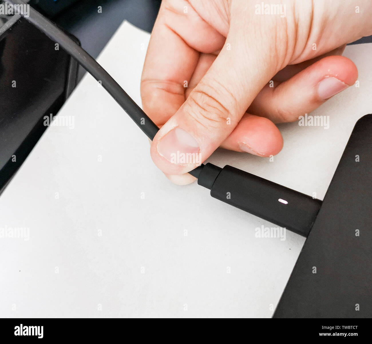 hand plug laptop power cord cable to charge notebook PC Stock Photo - Alamy