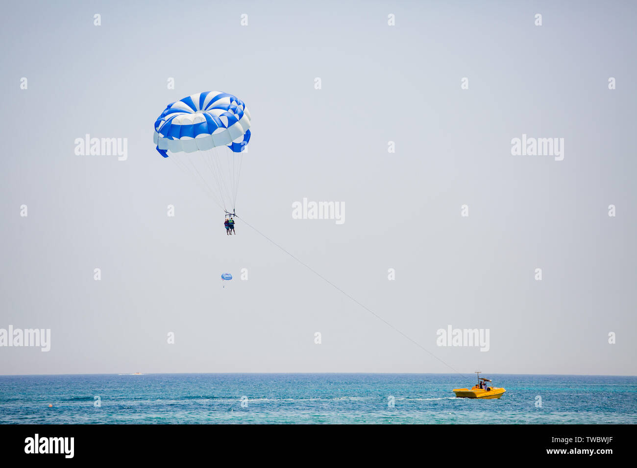 Parasailing water amusement - flying on a parachute behind a boat on a ...