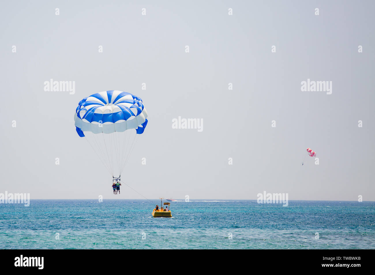 Parasailing water amusement - flying on a parachute behind a boat on a ...