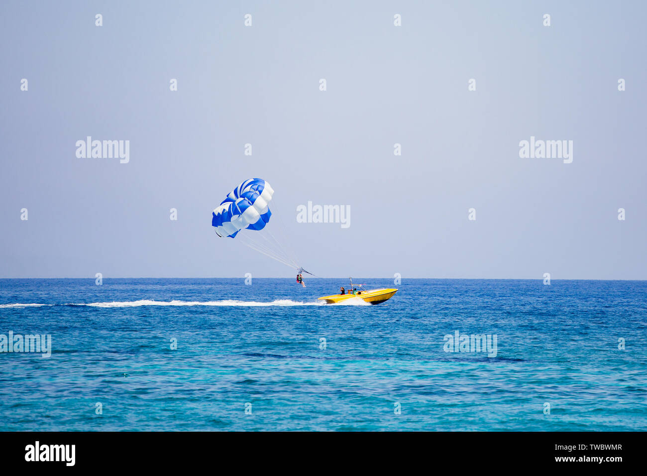 Parasailing water amusement - flying on a parachute behind a boat on a ...