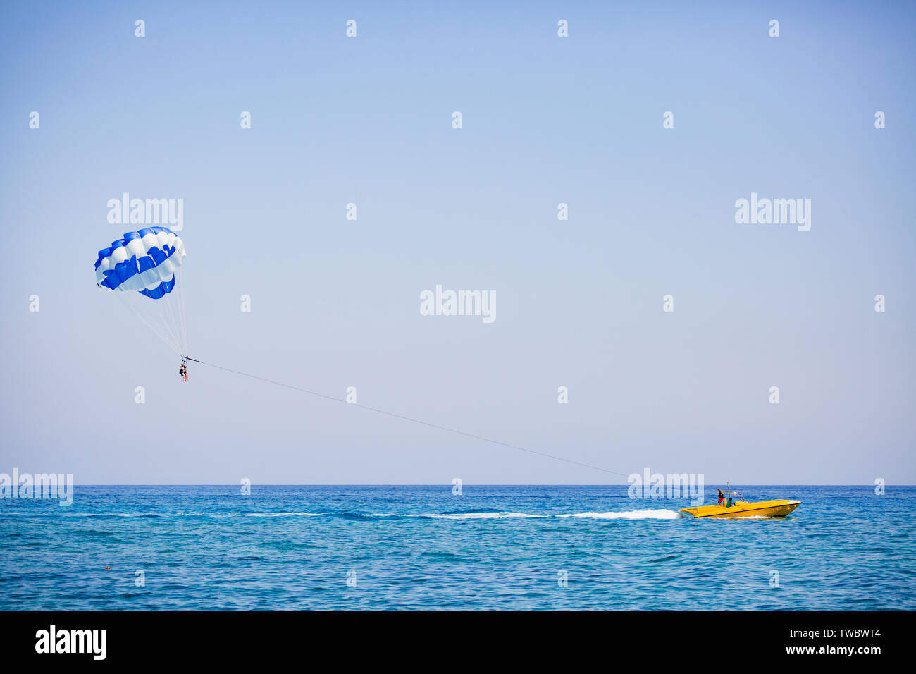 Parasailing water amusement - flying on a parachute behind a boat on a ...