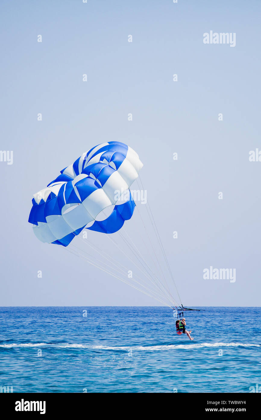 Parasailing water amusement - flying on a parachute behind a boat on a ...