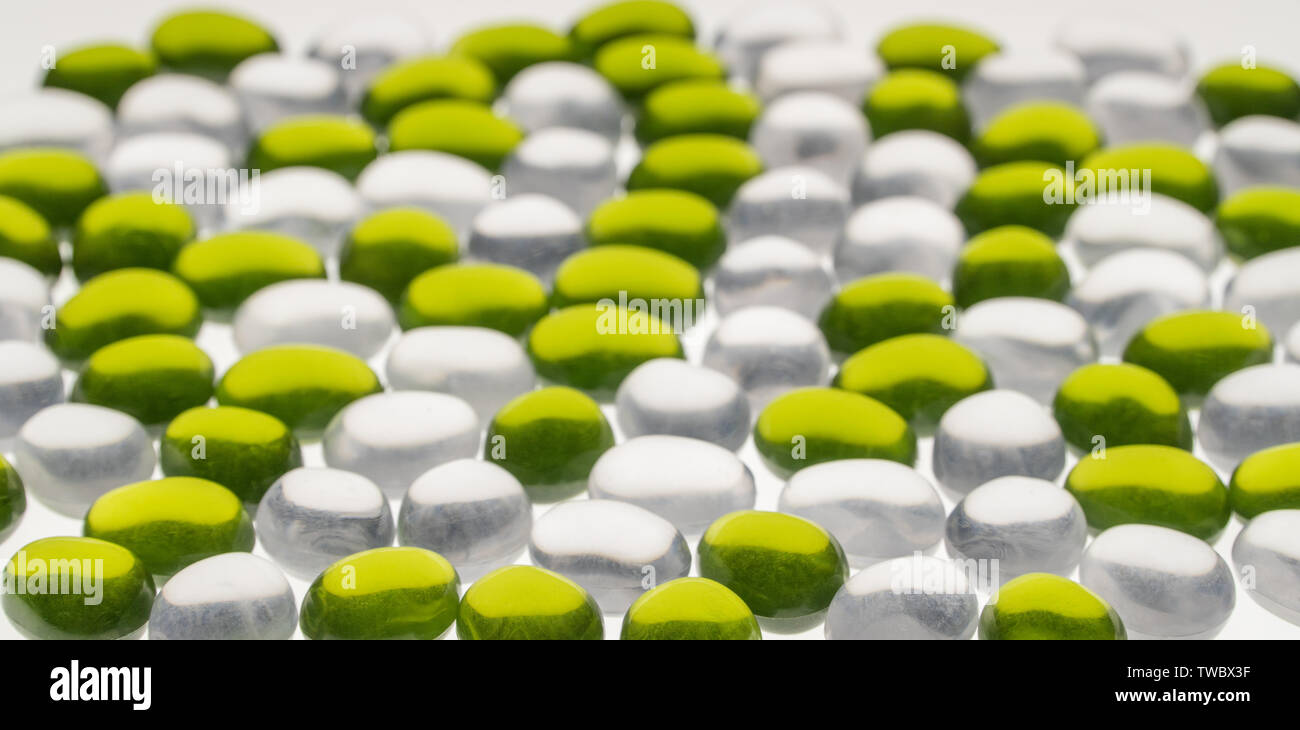 artificial round stones of green and white color. imitation pebbles ...