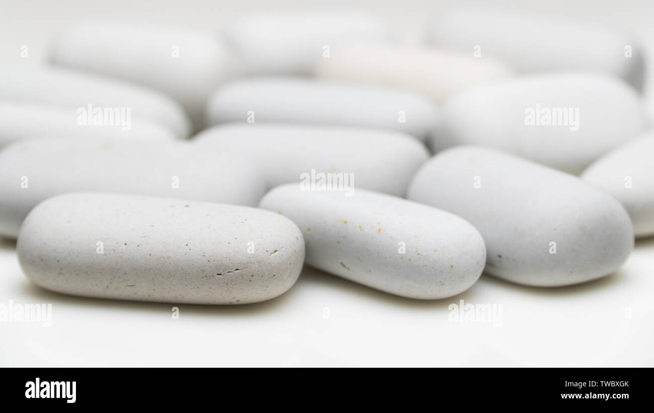 white smooth stones of elongated shape Stock Photo - Alamy