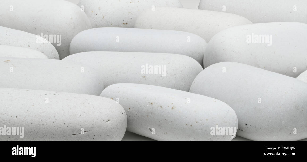 background of white smooth stones of elongated shape Stock Photo - Alamy