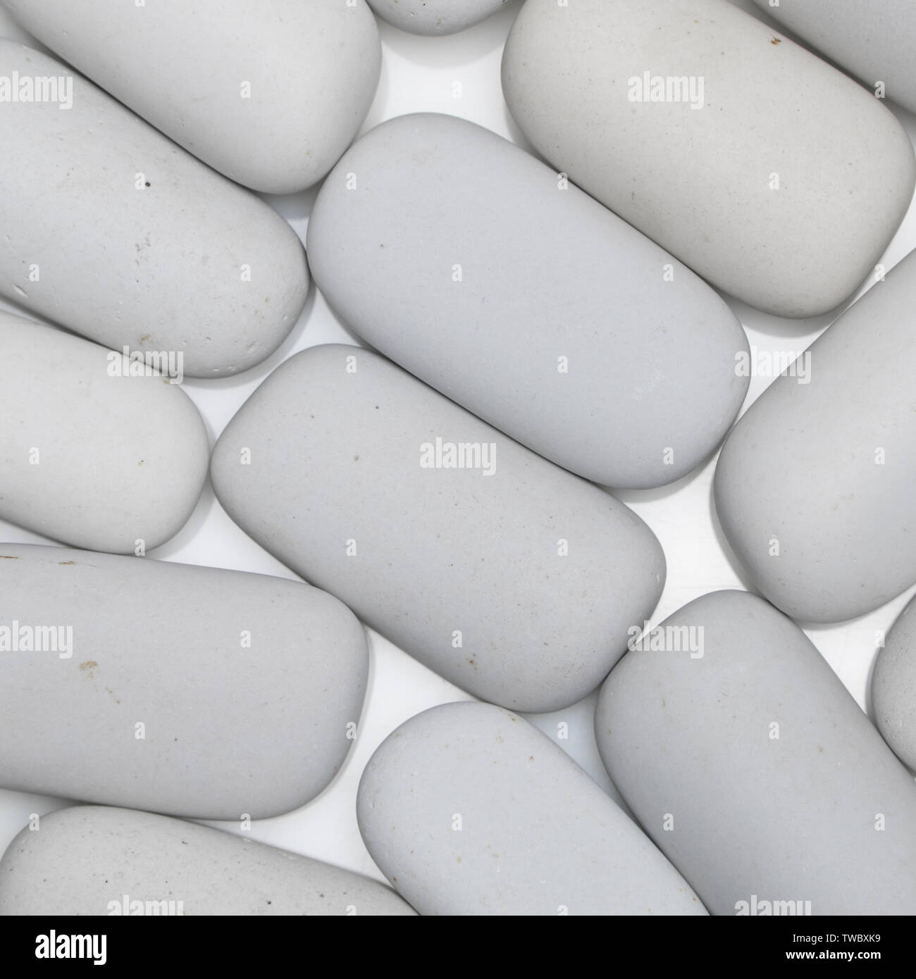 background of white smooth stones of elongated shape, top view Stock ...