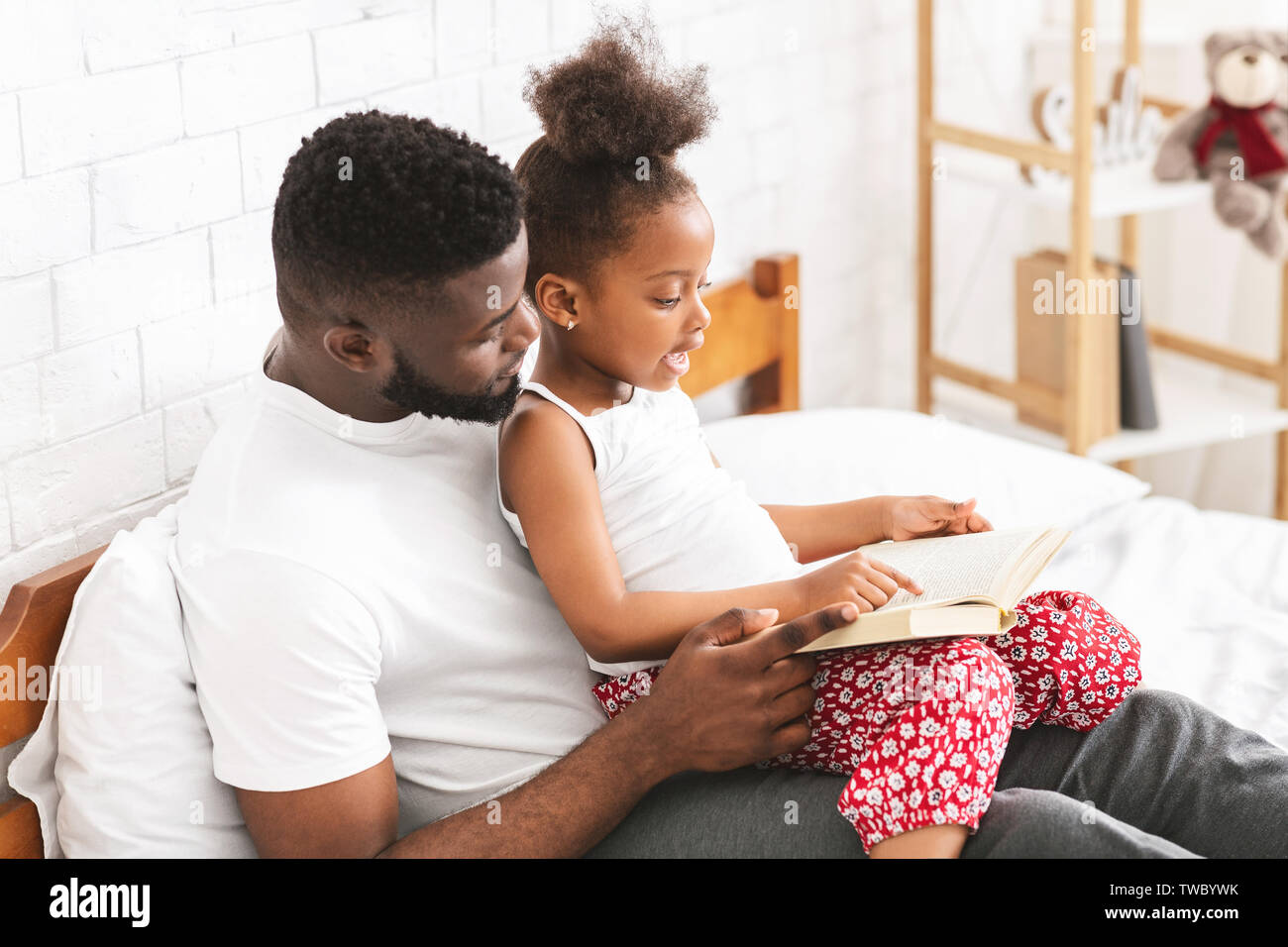 Early development at home. African dad teaching his little daughter to ...