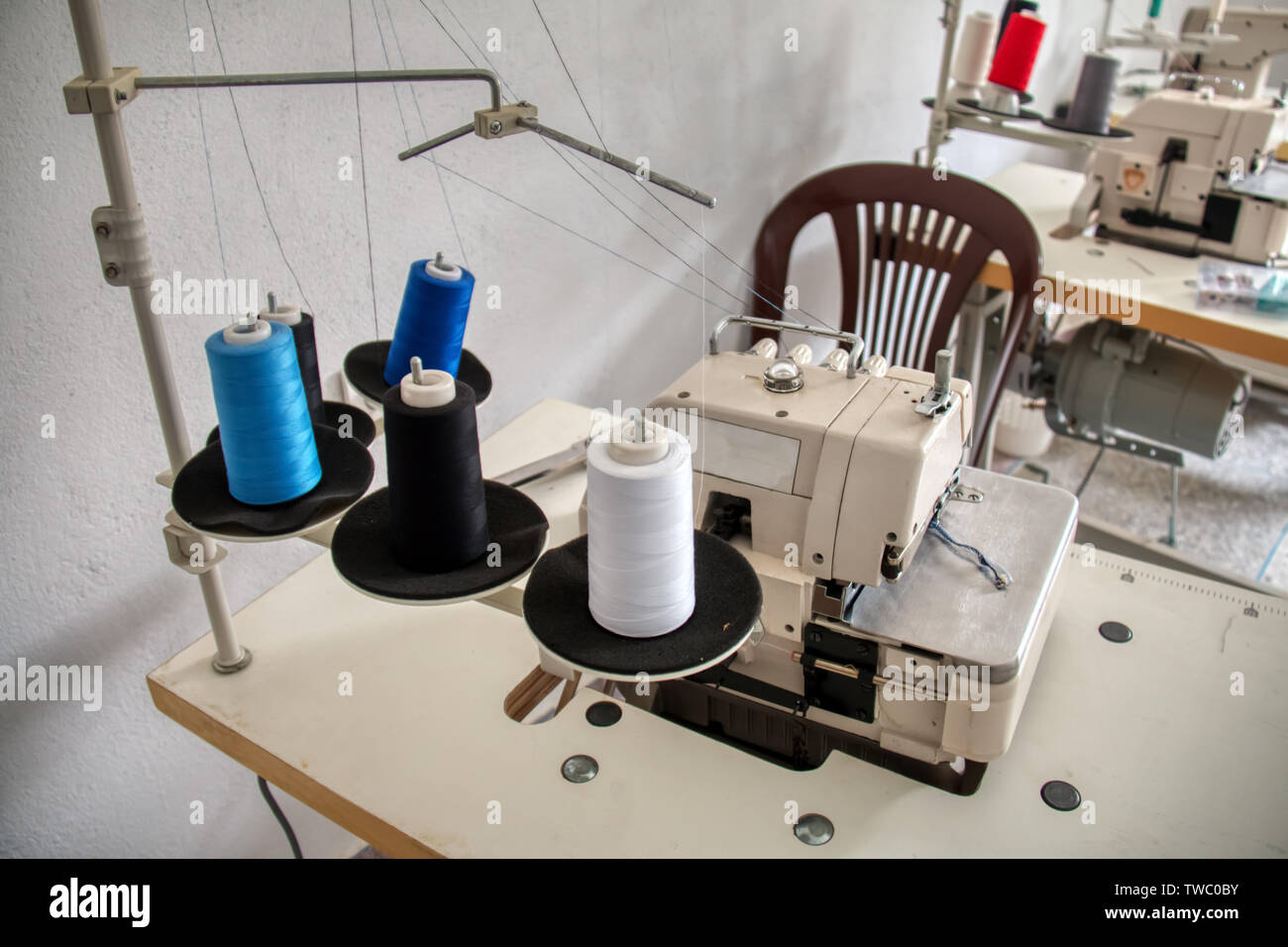 Industrial sewing machine installed in a sewing workshop Stock Photo ...