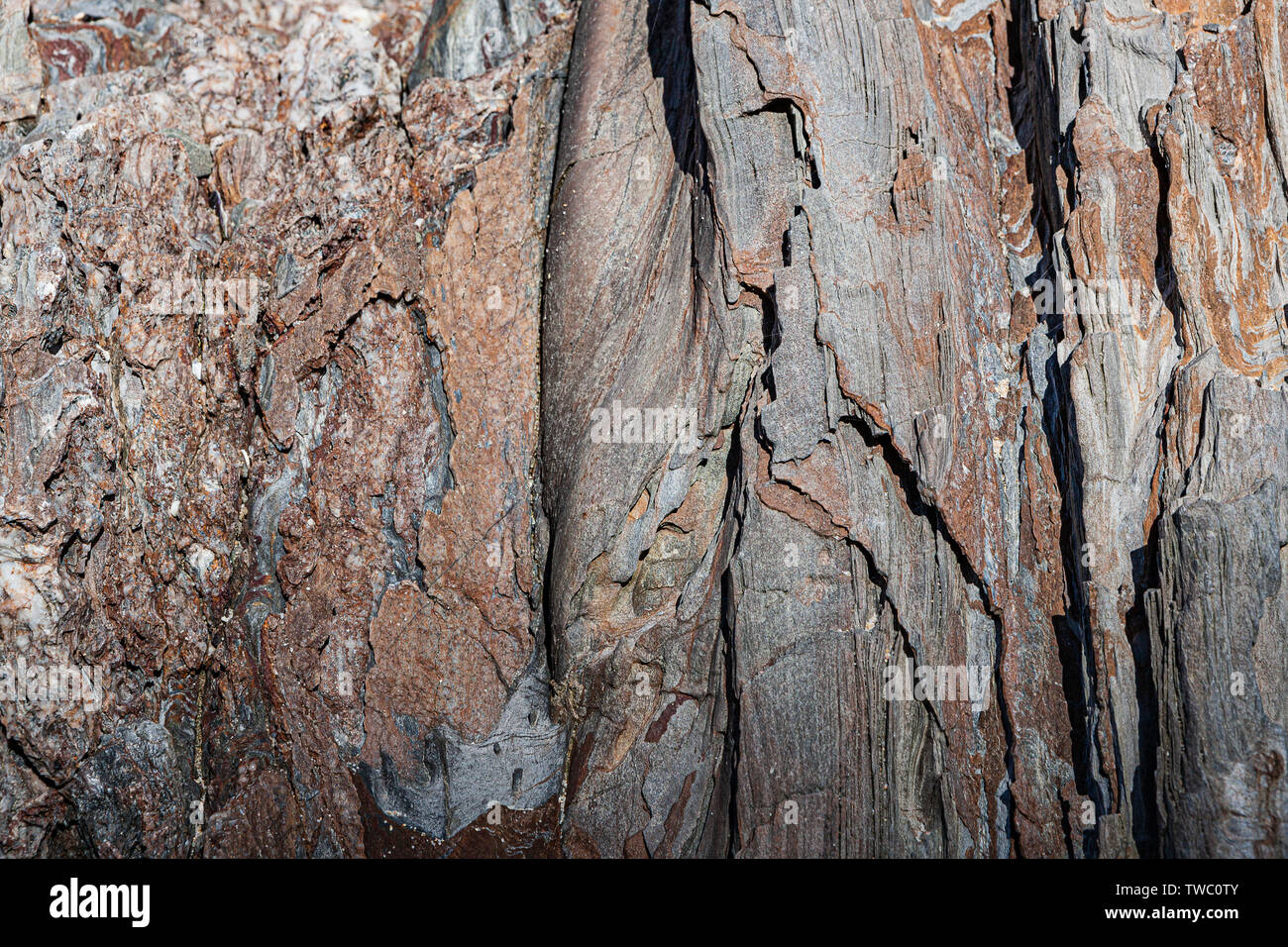 Natural rock splitting in layers, rock has various colors forming an ...