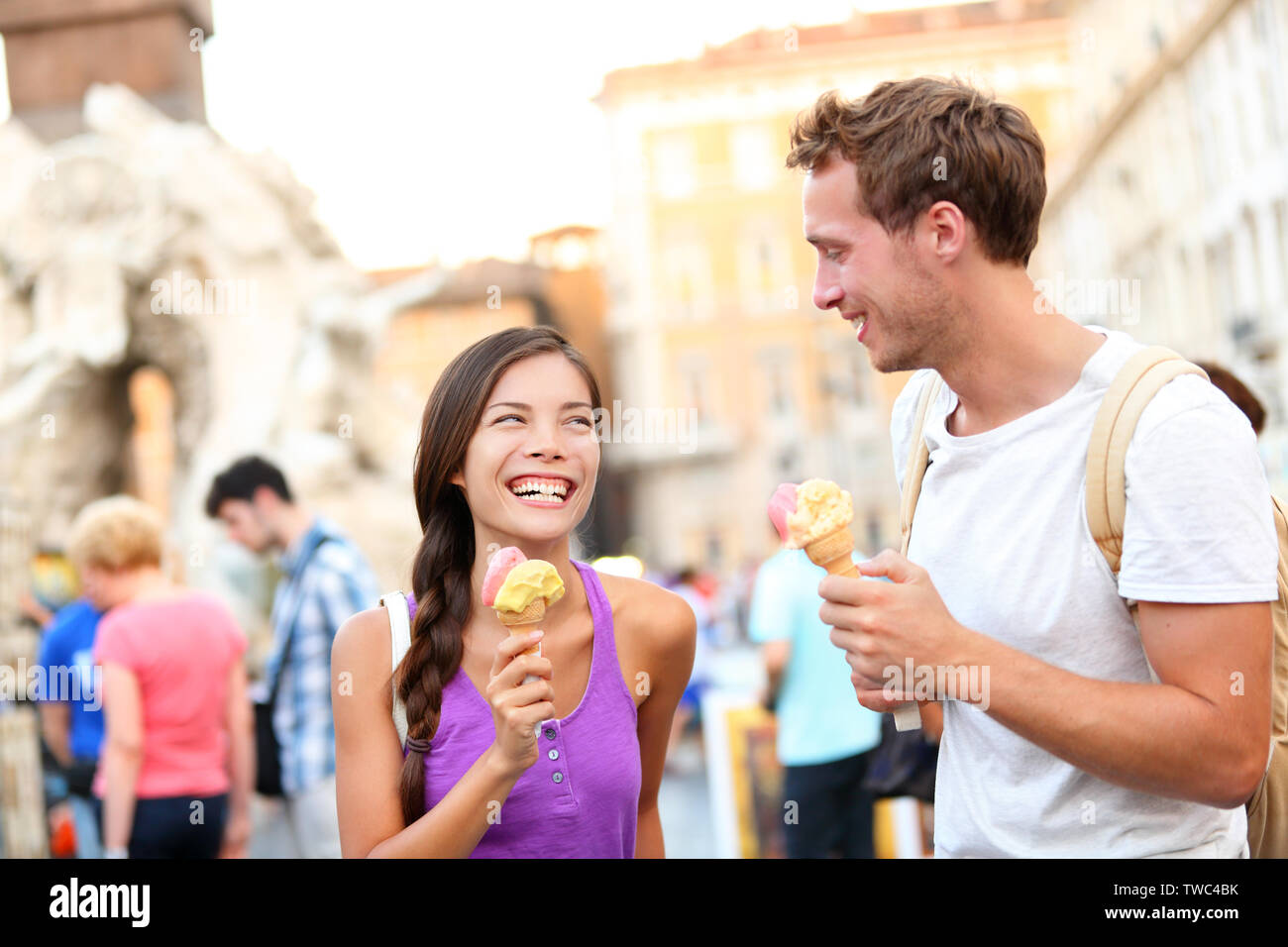 Ice cream - couple eating gelato in Rome on Piazza Navona. Couple ...