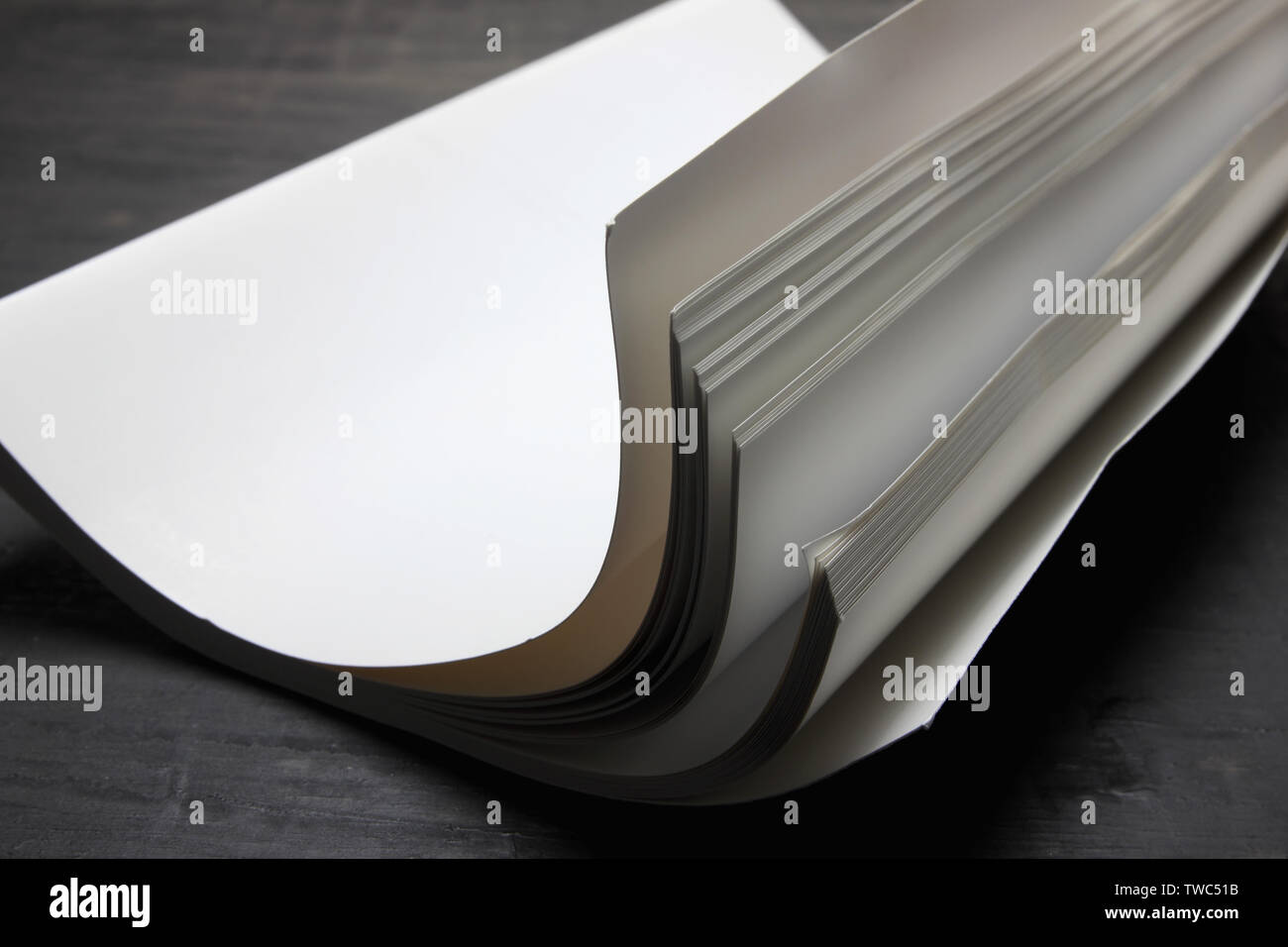 Rolled Up Book on Wooden Background Stock Photo - Alamy