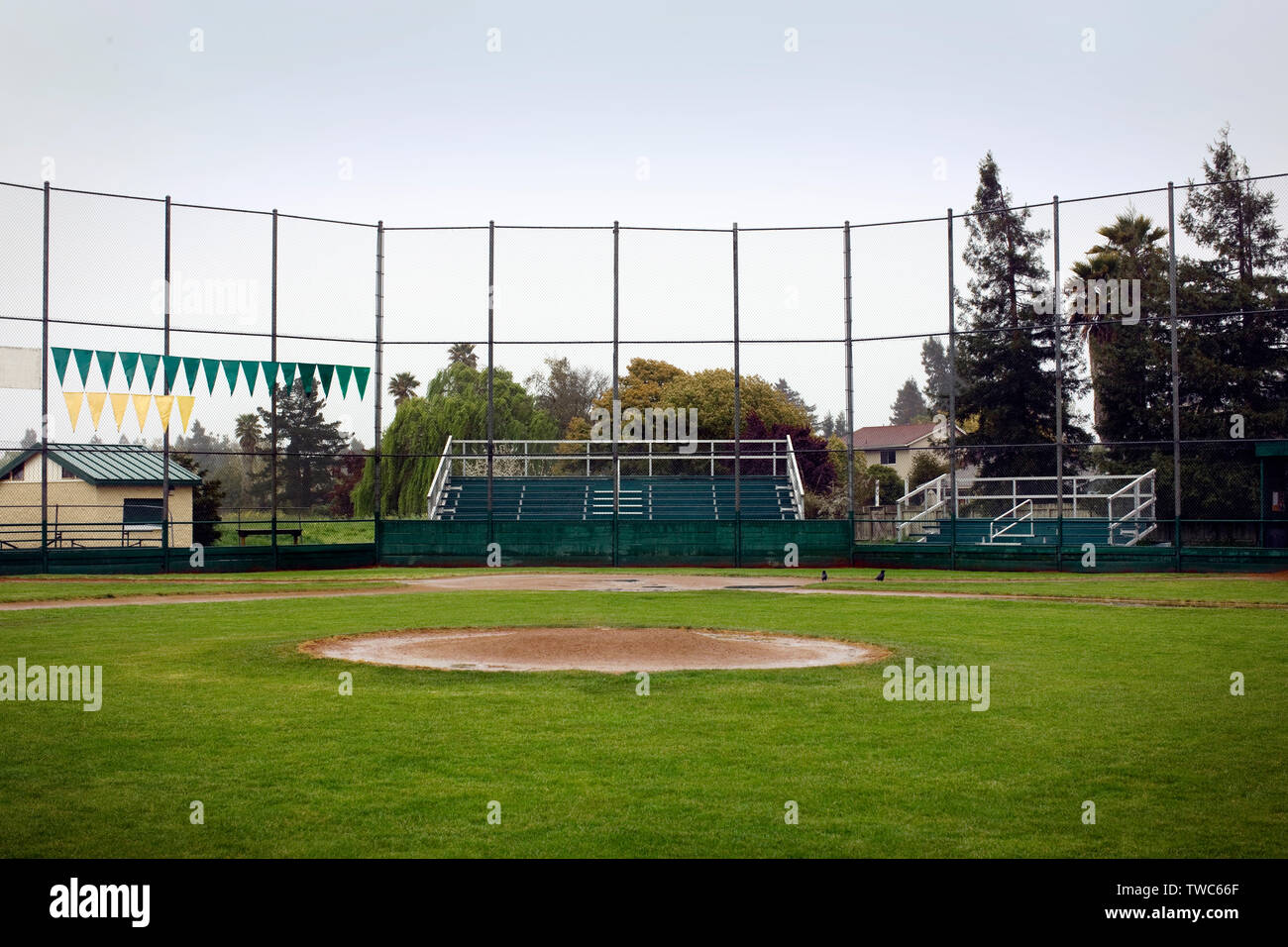 Empty baseball field surrounded by a high fence Stock Photo - Alamy