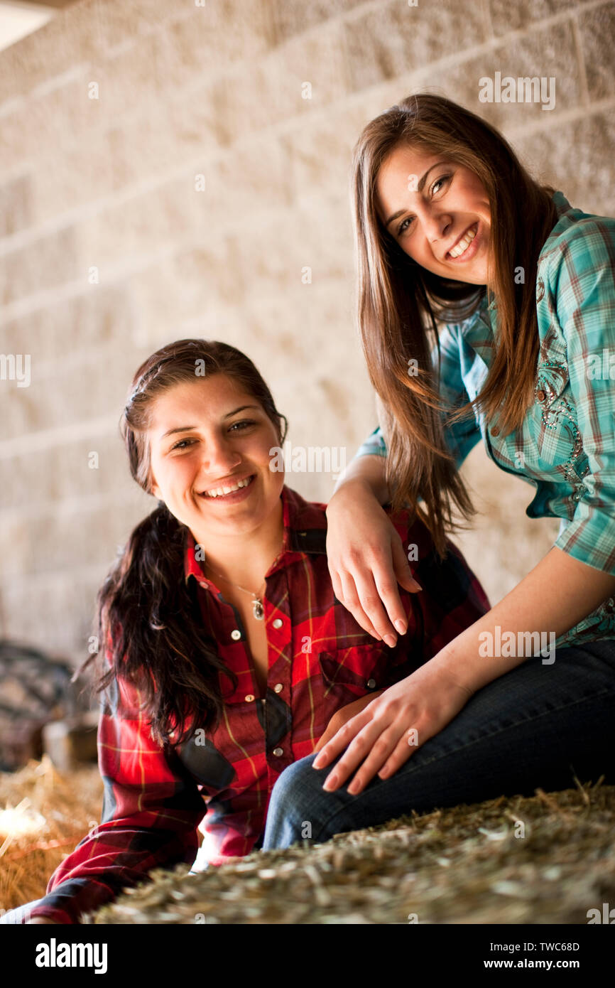 Portrait of two farm workers inside a barn Stock Photo - Alamy