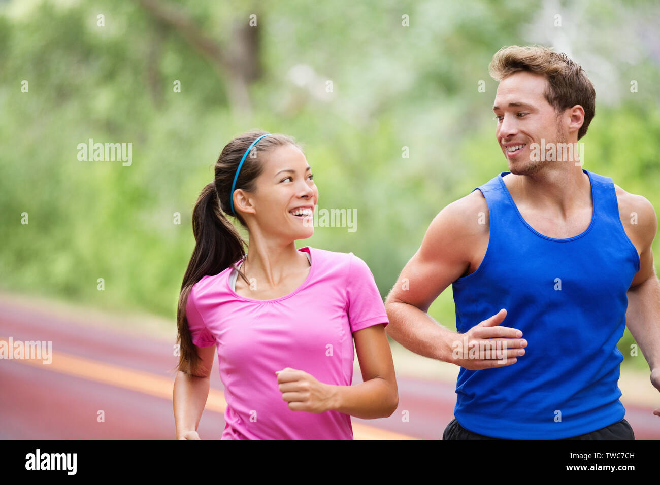 Healthy lifestyle - Running fitness couple jogging laughing, talking ...