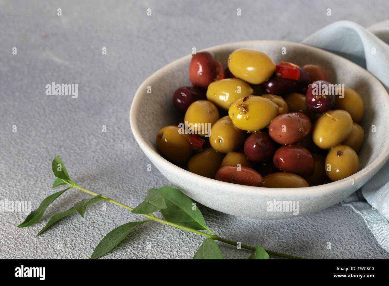 Kalamata red and green olives with herbs and herbs Stock Photo - Alamy