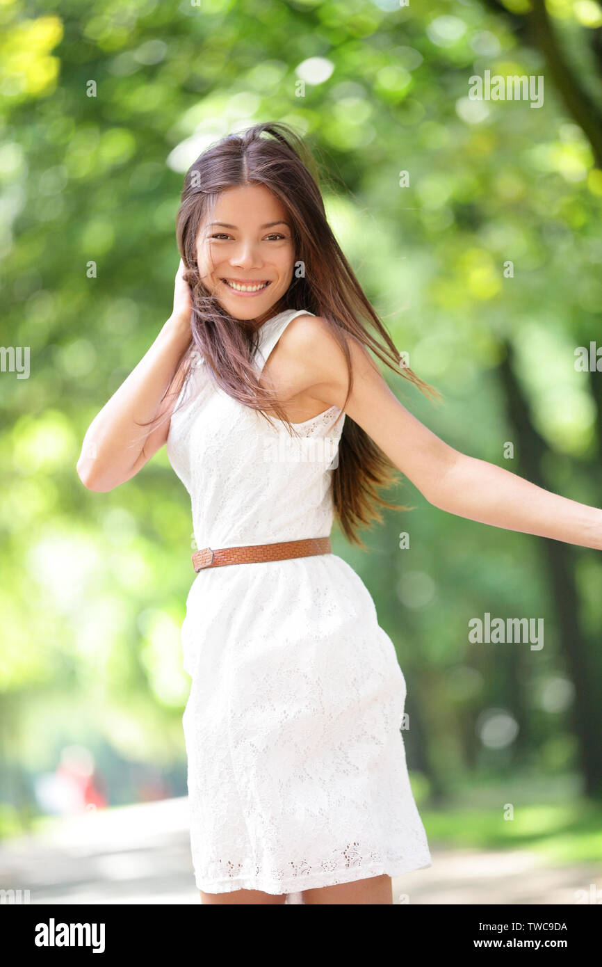 Asian woman happy running in summer / spring city park joyful and ...