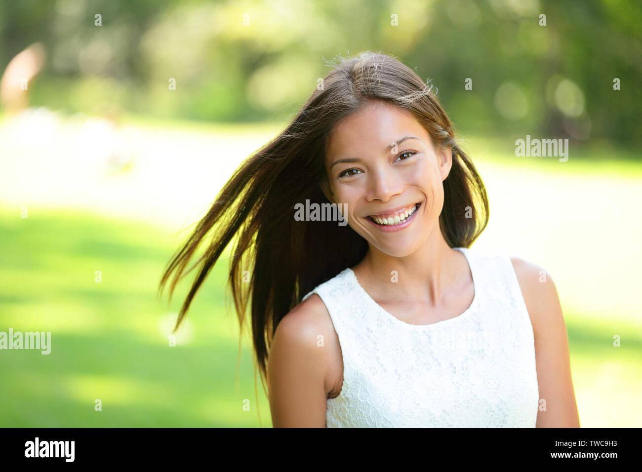 Asian girl spring portrait in park. Smiling happy mixed race Asian ... Asian girl spring portrait in park. Smiling happy mixed race Asian ...
