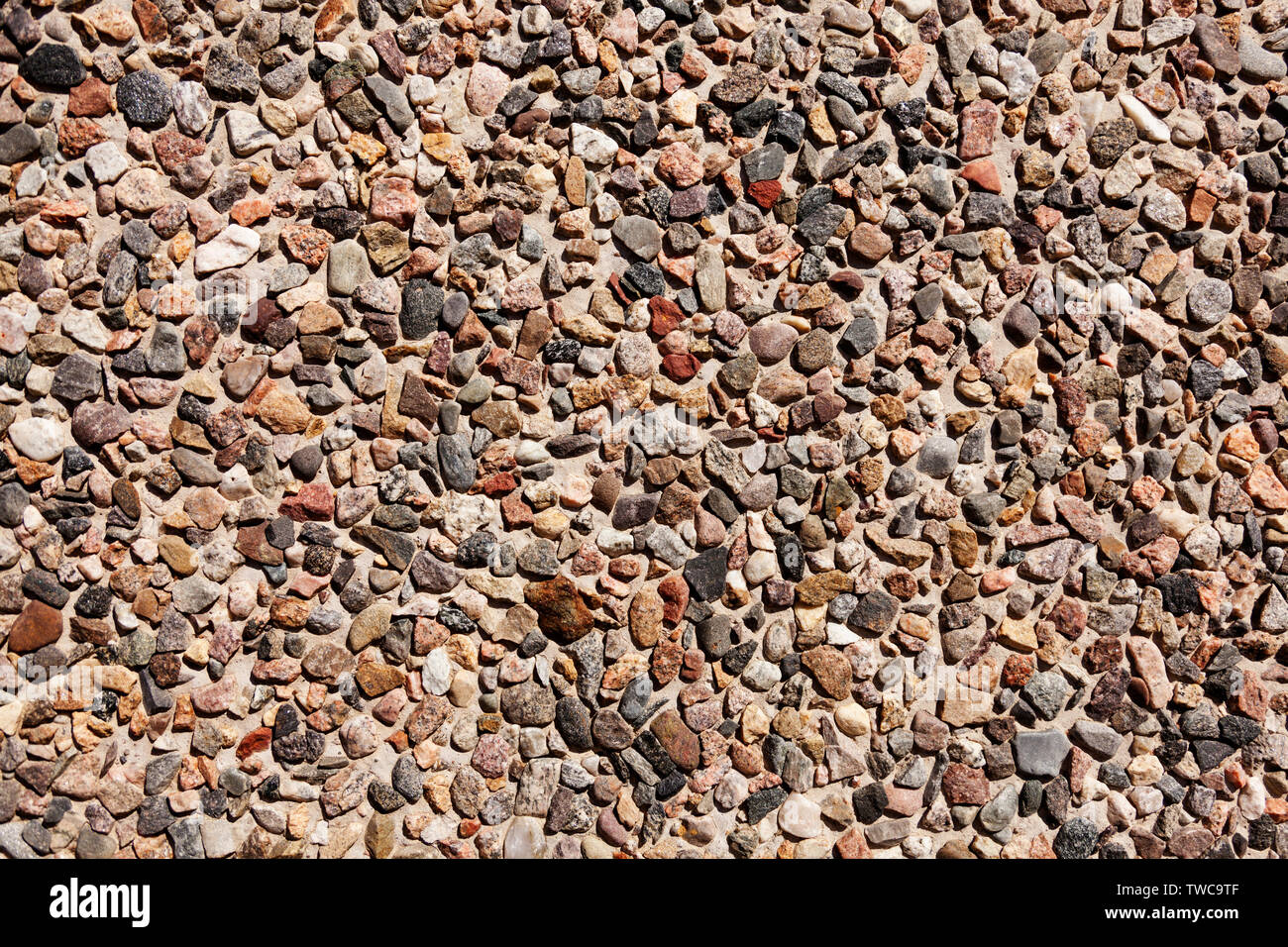 small stones in concrete wall as texture Stock Photo - Alamy