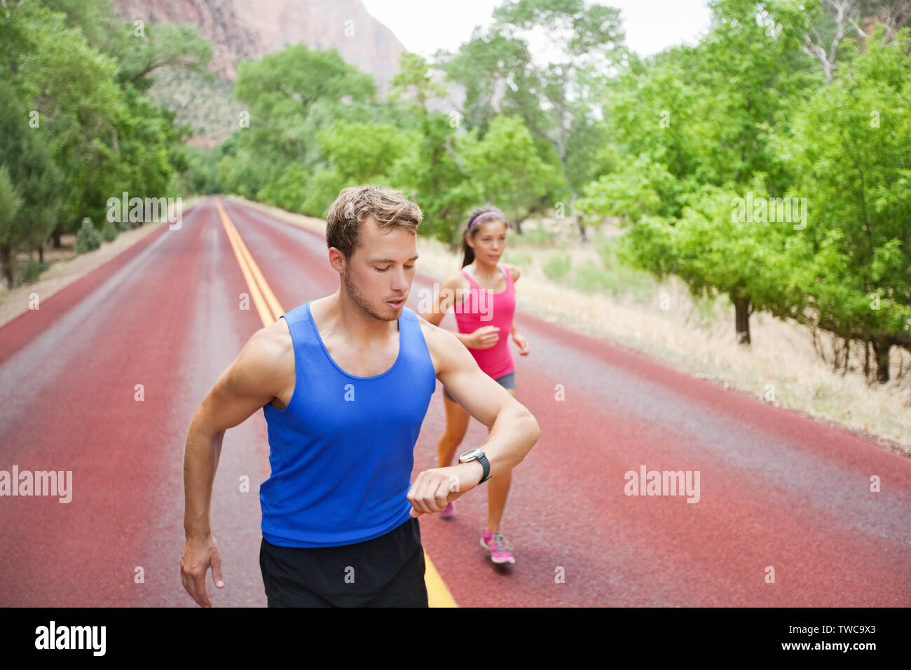 Runners training - young multiracial couple running exercising ...