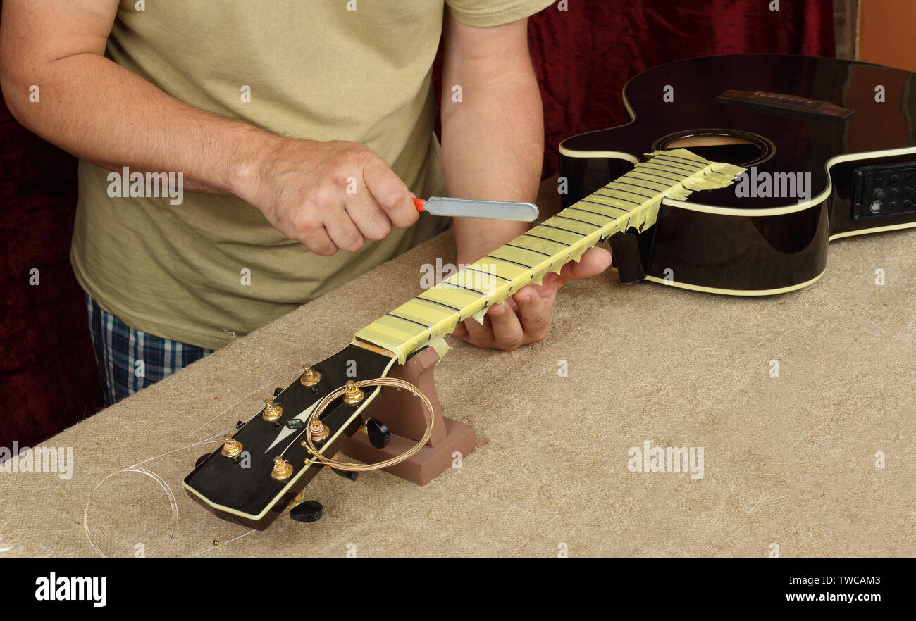 Musical instrument guitar repair and service - Worker sharpen special ...
