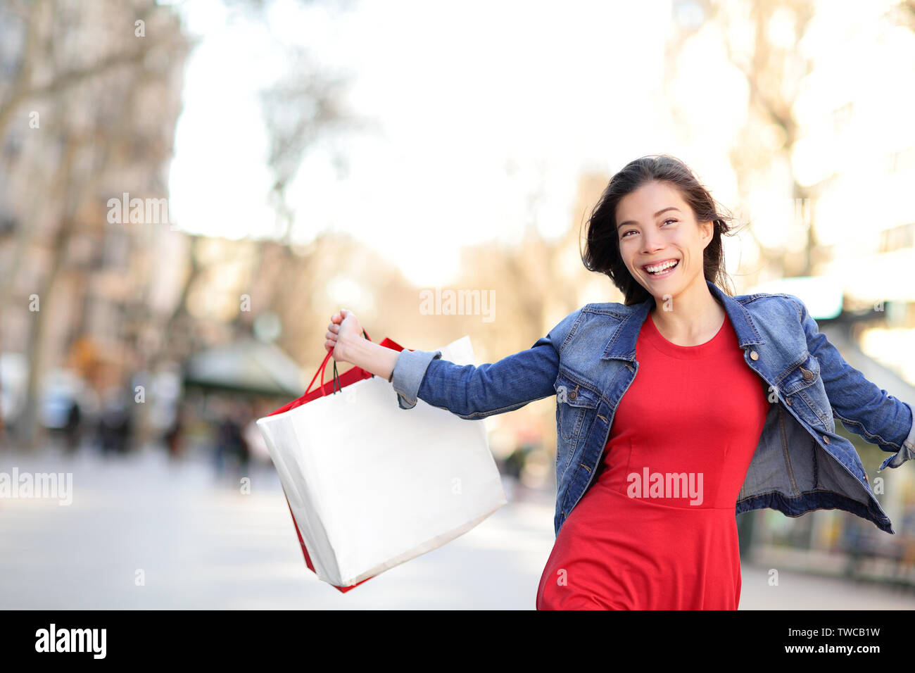 Shopping girl happy shopping outside. Beautiful woman running joyful ...