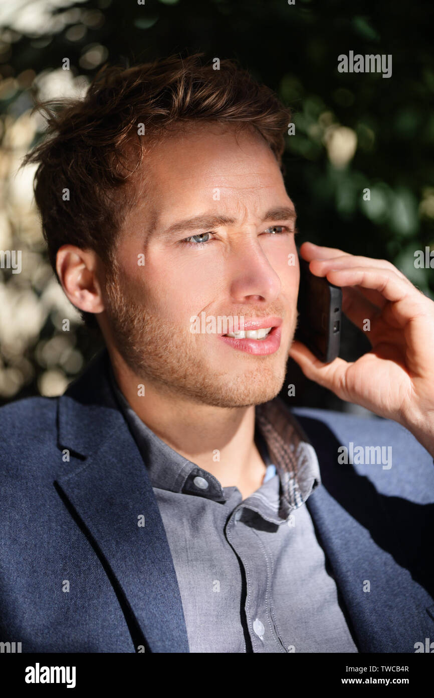 Young urban professional man talking on smartphone. Close up portrait ...