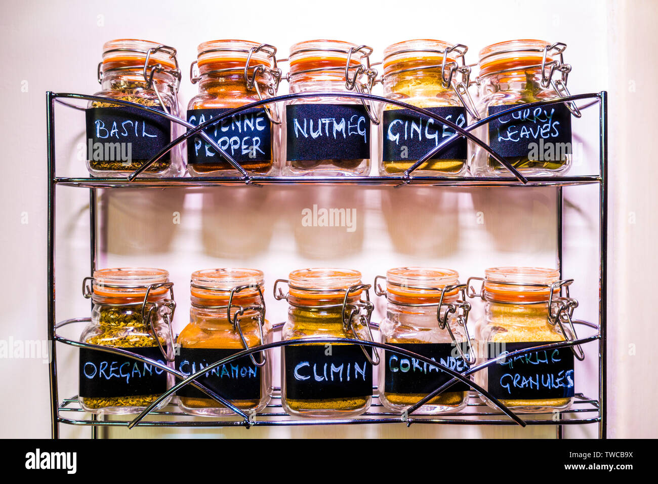 Spices in small traditional glass storage jars, with lids and rubber ...