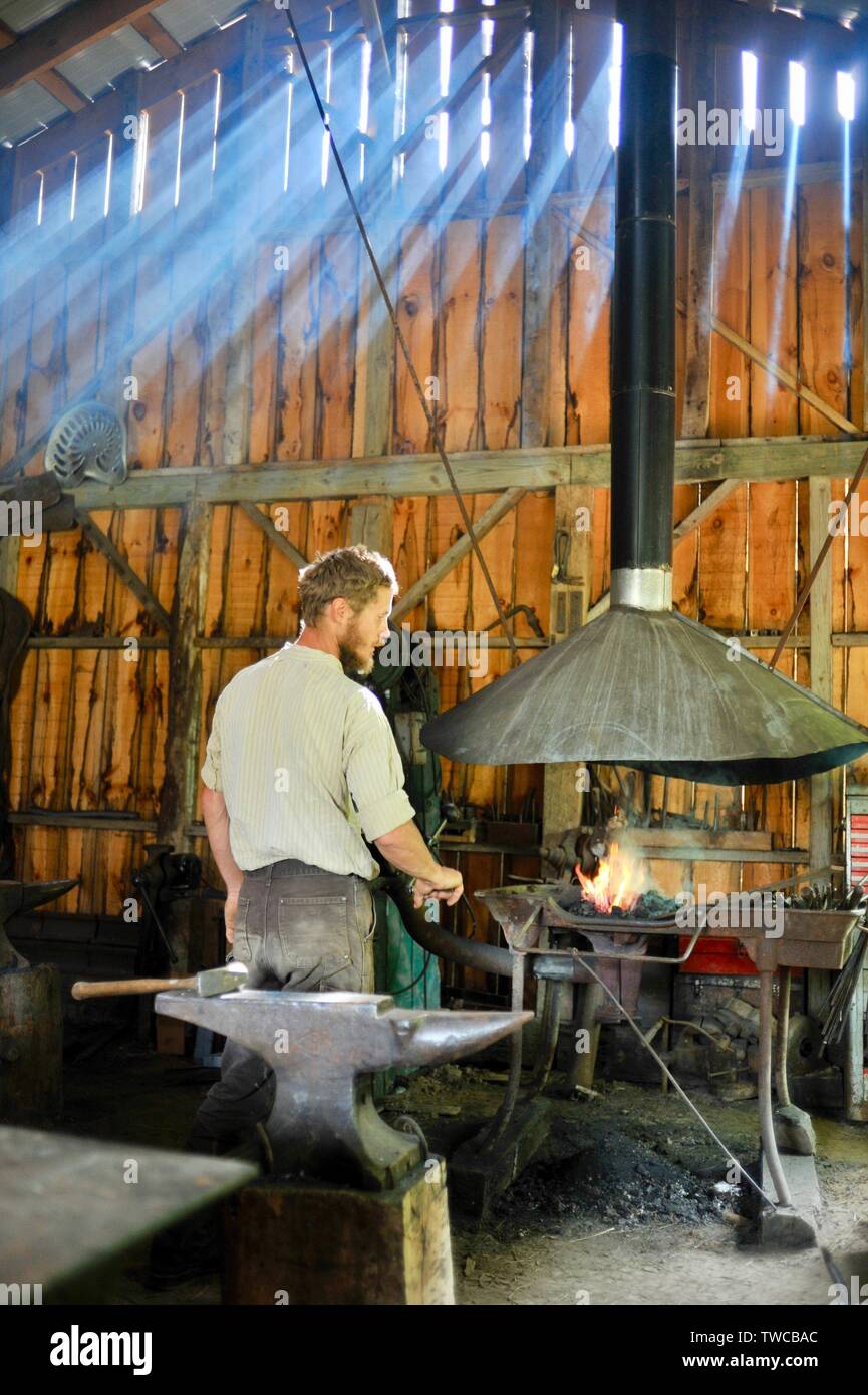 Light rays passing through wooden siding of blacksmith workshop, rural ...