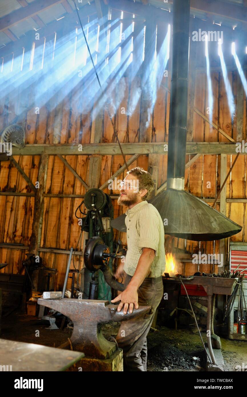 Light rays passing through wooden siding of blacksmith workshop, rural ...