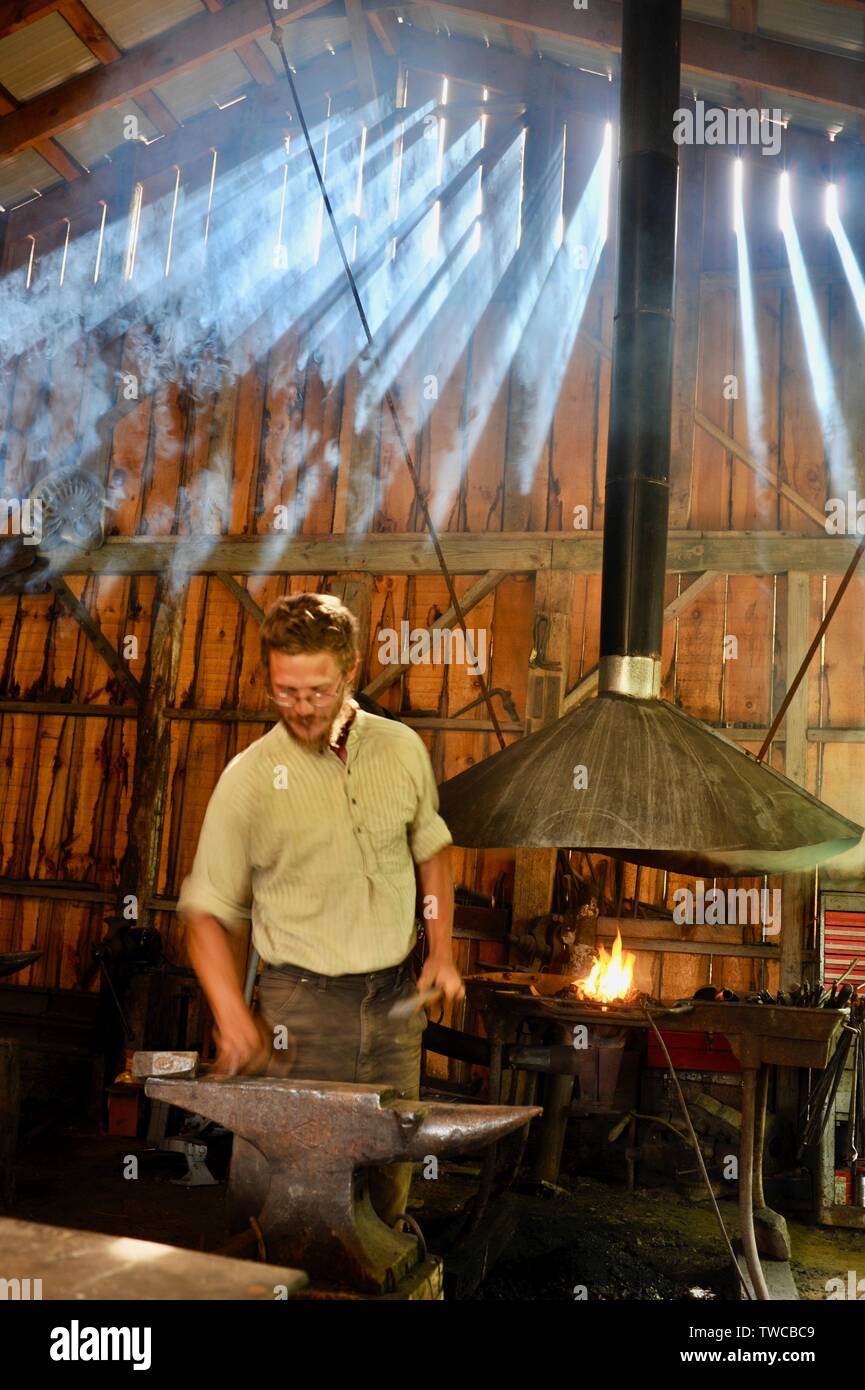 Light rays passing through wooden siding of blacksmith workshop, rural ...