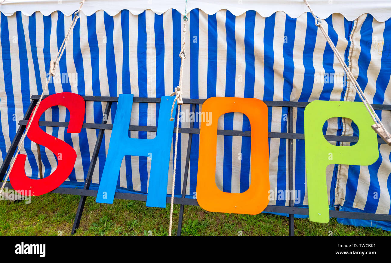 The word shop in large colourful letters outside a blue and white ...