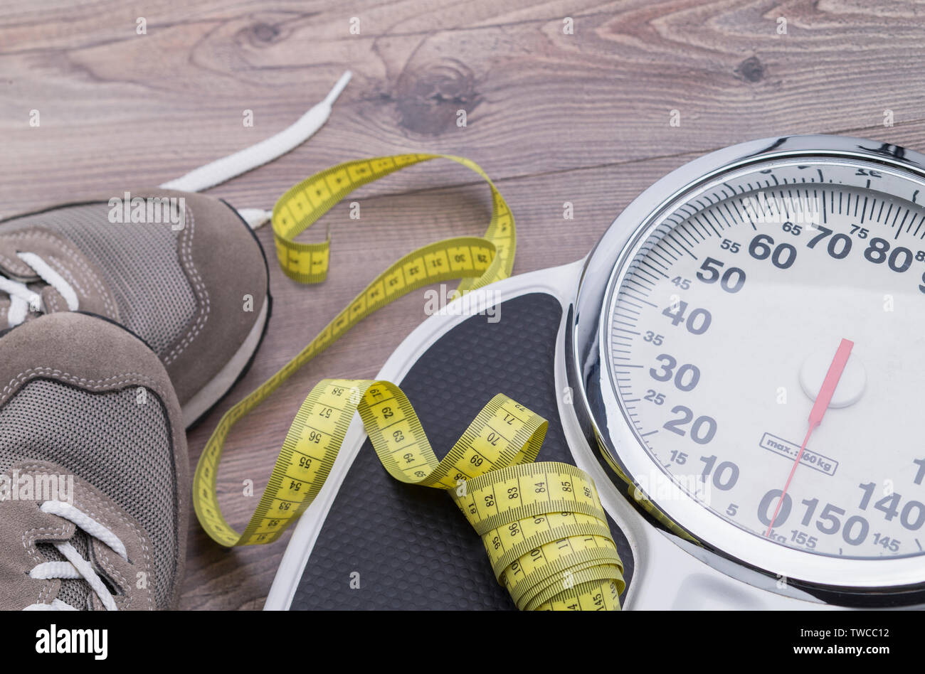The image shows running shoes with tape measure and weighing scales on ...